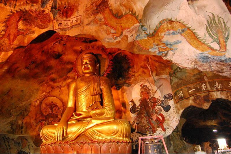 Buddha statue and Chinese deities painting on wall